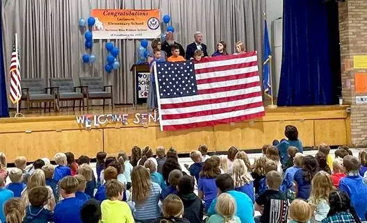 Hoeven presents US flag to honored Larimore school | KNOX News Radio ...